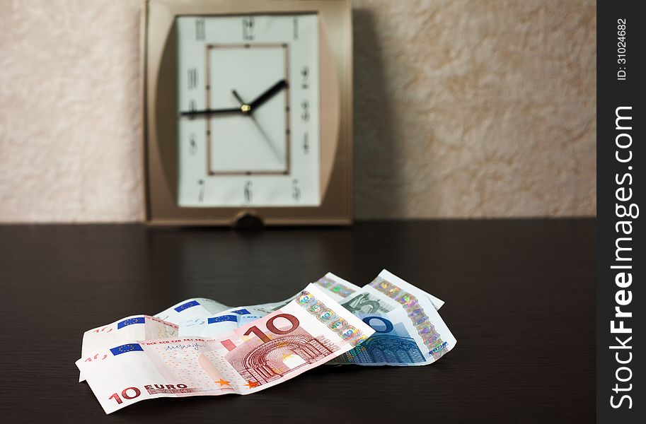 1+ Money table wall clock behind Free Stock Photos - StockFreeImages